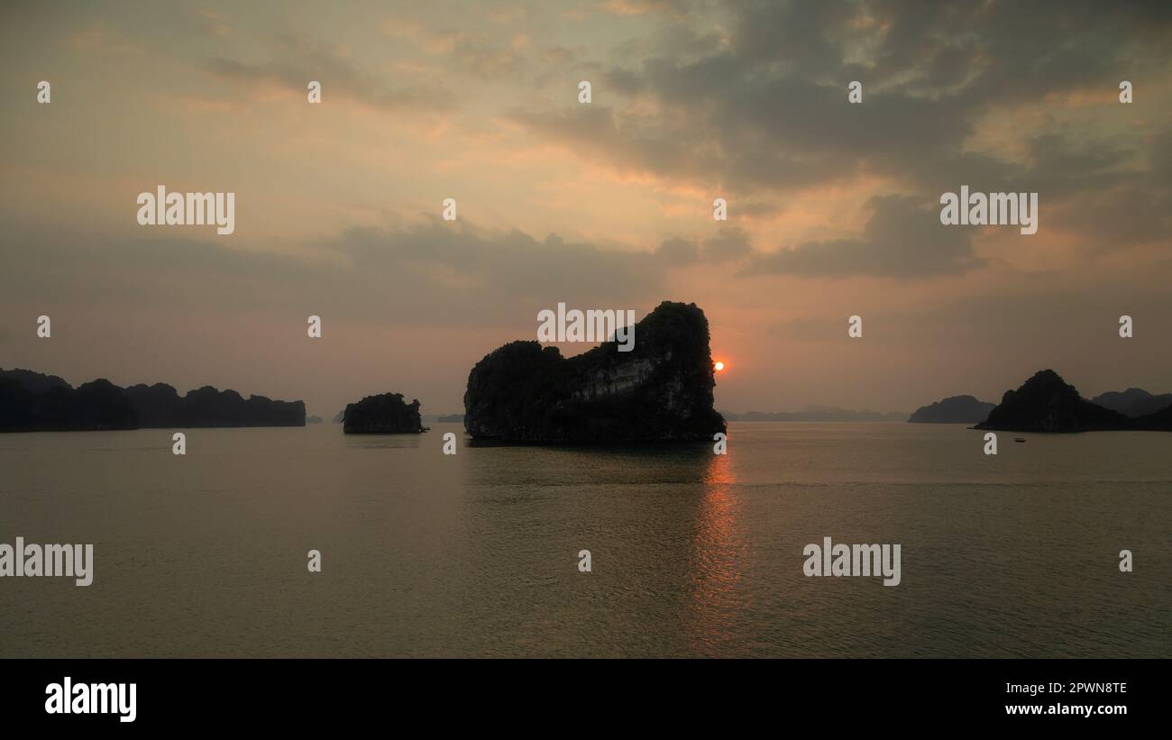Sunset over the karst seascape of Ha Long Bay in Vietnam, Southeast ...