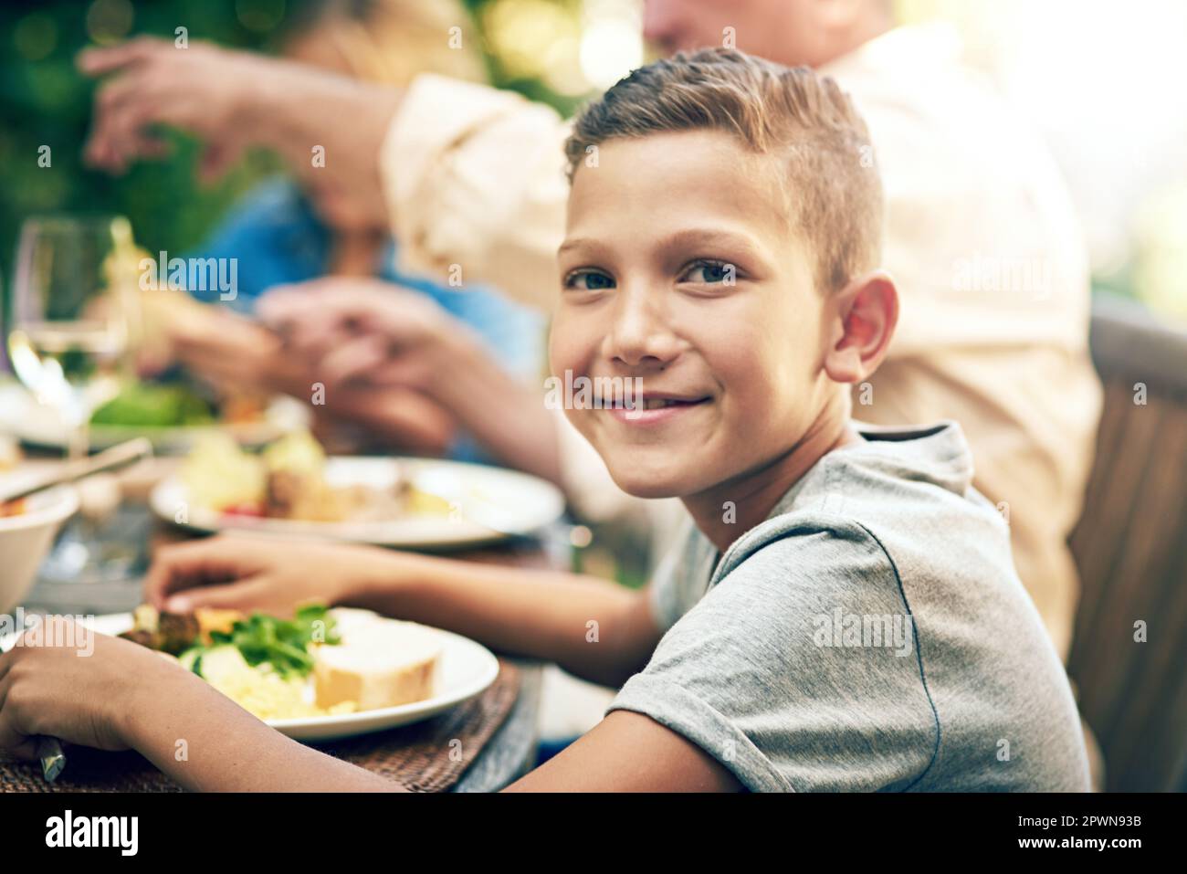 This food is yummy. Portrait of a happy little boy enjoying an outdoor ...