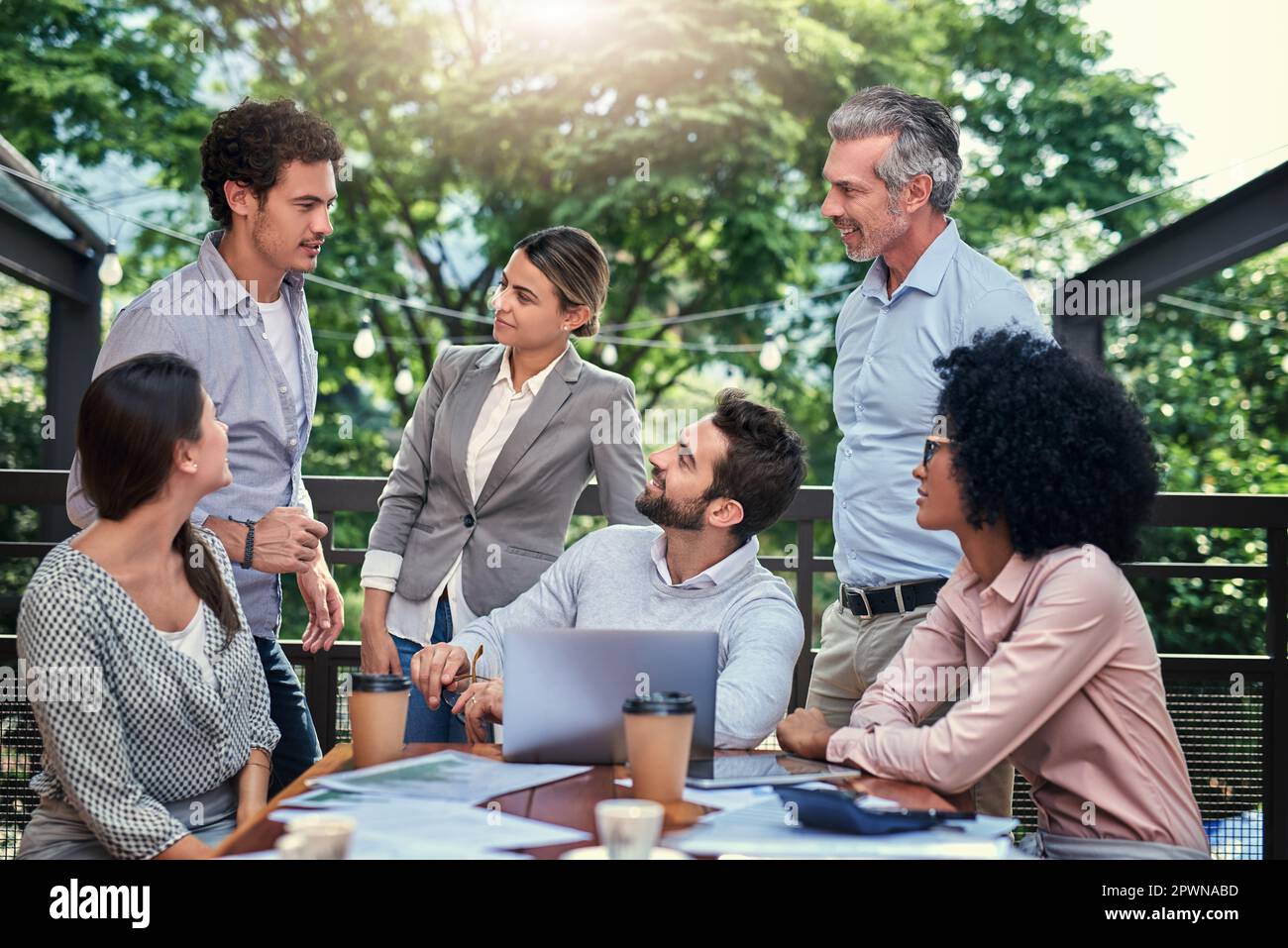 Doing some work outside of the office. a group of business colleagues ...