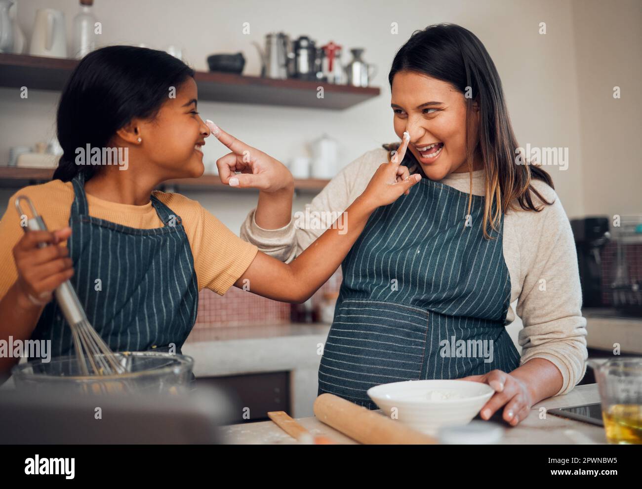 Mother, girl and cooking while playing with flour, having fun or bonding. Learning, education ...