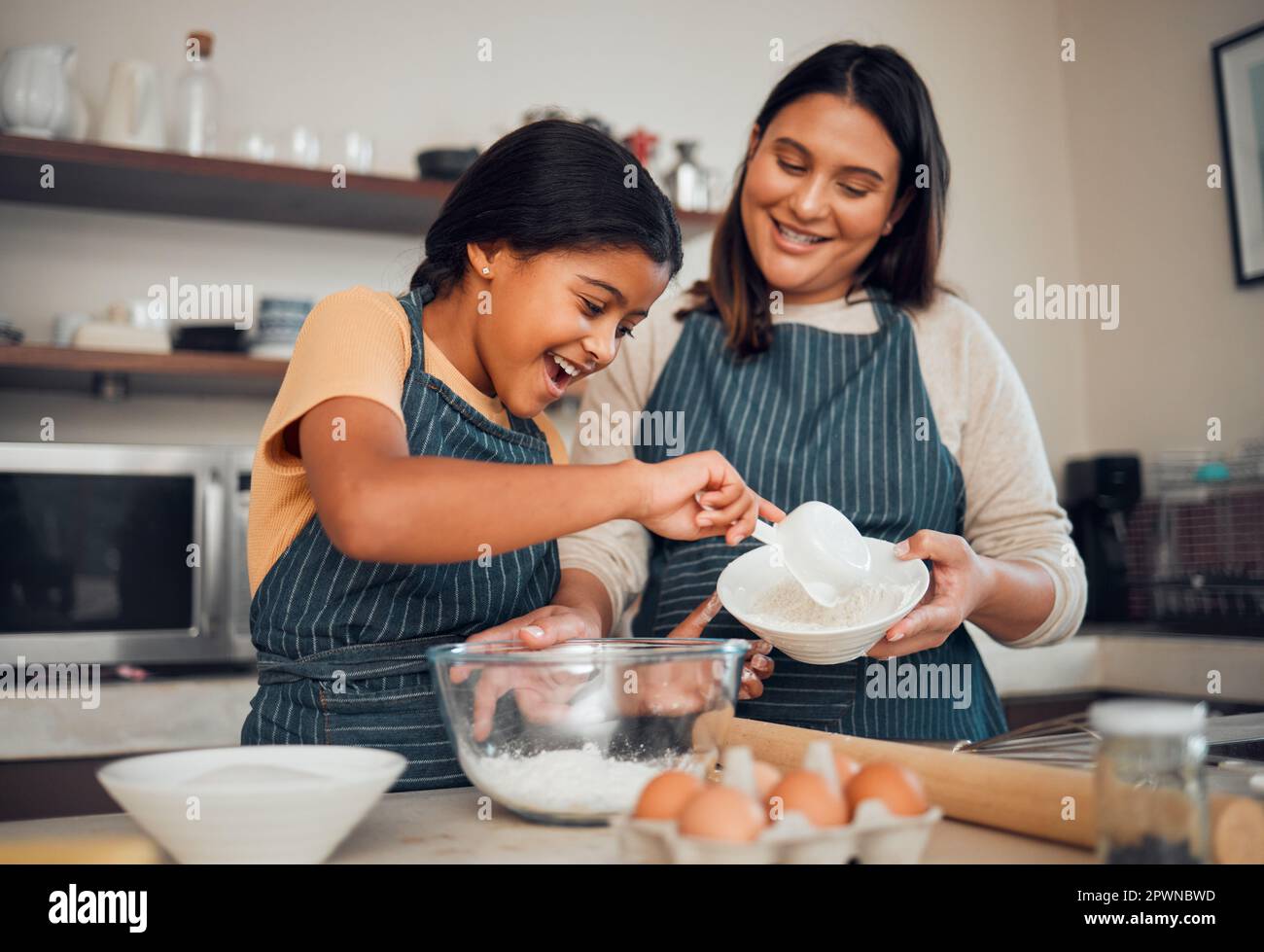 Baking, family and children with a mother and daughter learning about ...