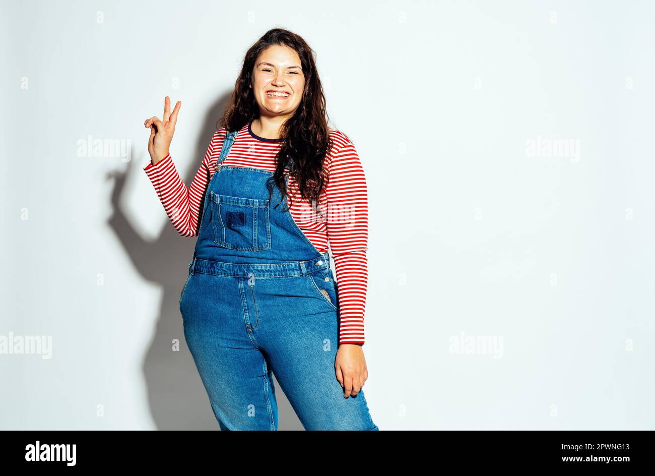 Plus size woman model posing in studio and having fun. Shots taken on ...