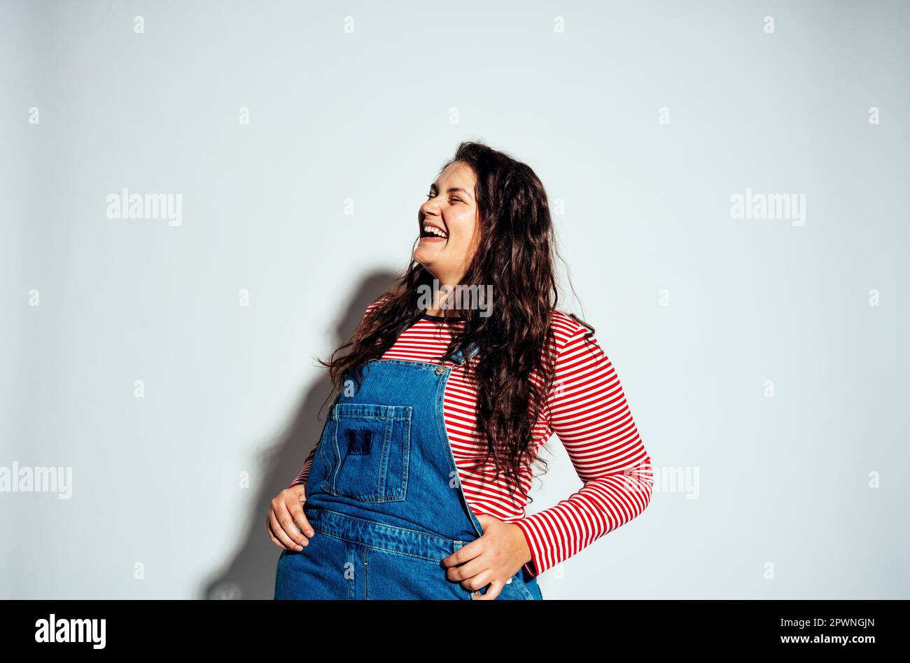 Plus size woman model posing in studio and having fun. Shots taken on ...