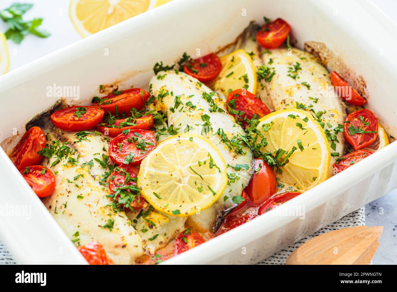Baked cod fillet with cherry tomatoes and butter. Healthy diet recipe ...