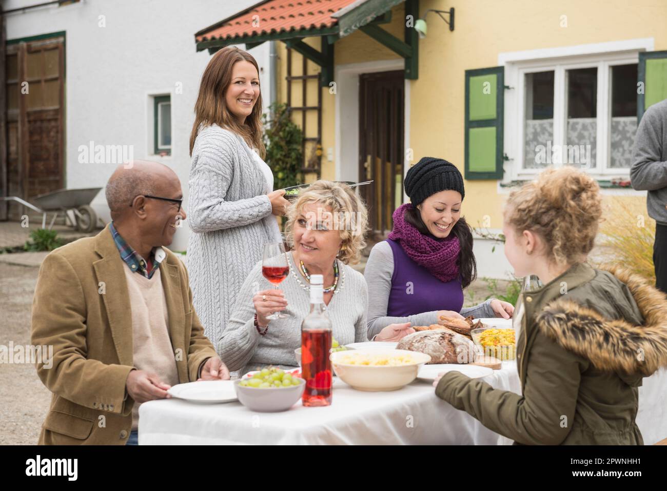 Family and friends enjoying outdoor party at farmhouse, Bavaria ...