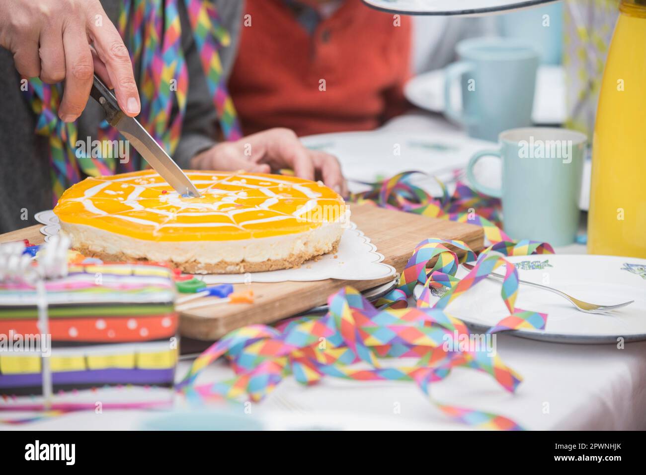 Man cutting birthday cake, Bavaria, Germany Stock Photo - Alamy