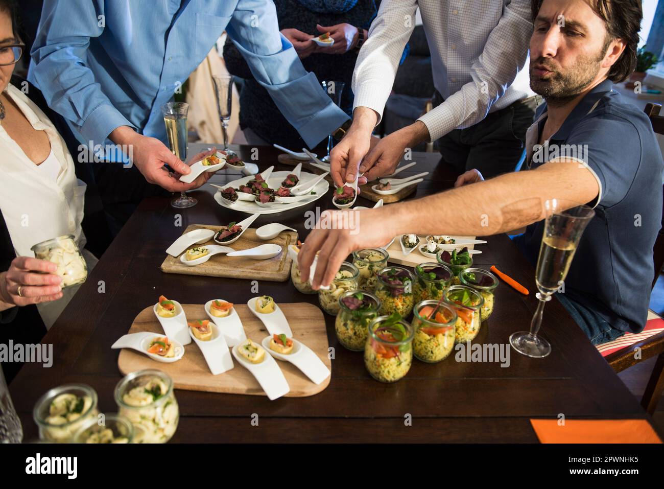 Party guests helping themself with the buffet Stock Photo - Alamy