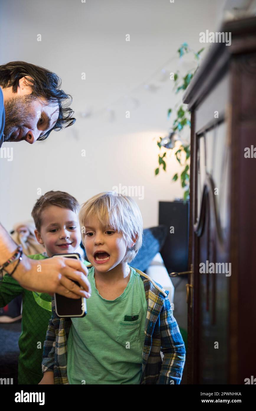 Father showing his children something on the smart phone Stock Photo ...