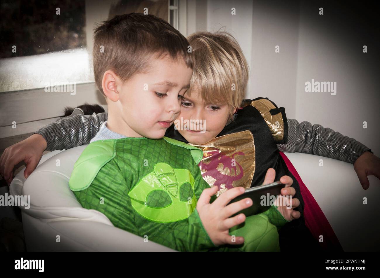Two boys using smart phone at home Stock Photo - Alamy
