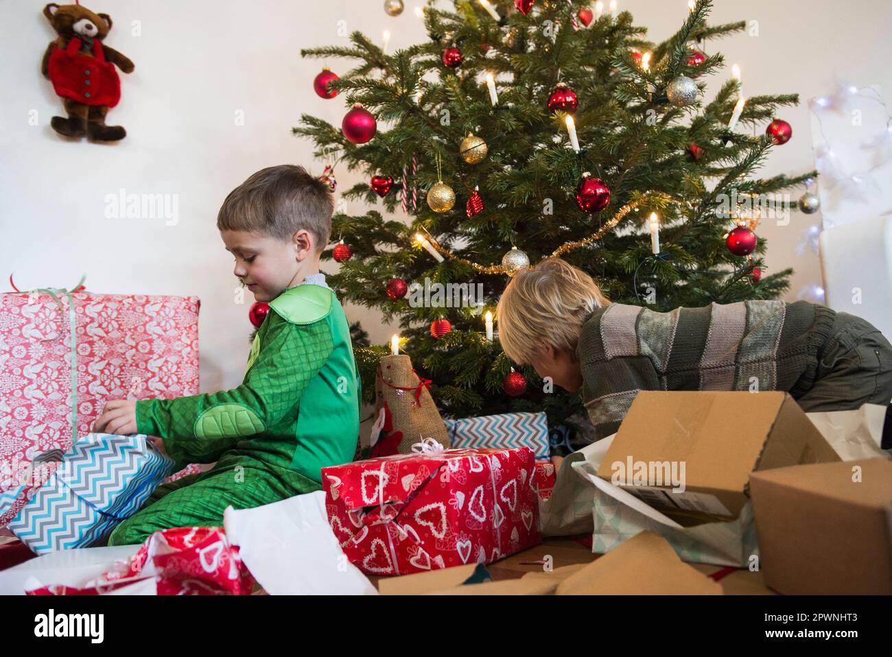 Children opening Christmas gift at home Stock Photo - Alamy