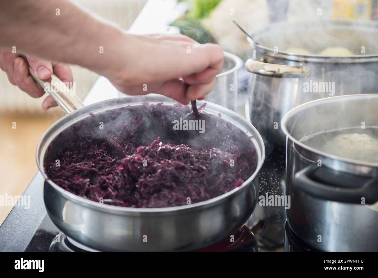 Chef cooking red cabbage on stove Stock Photo - Alamy
