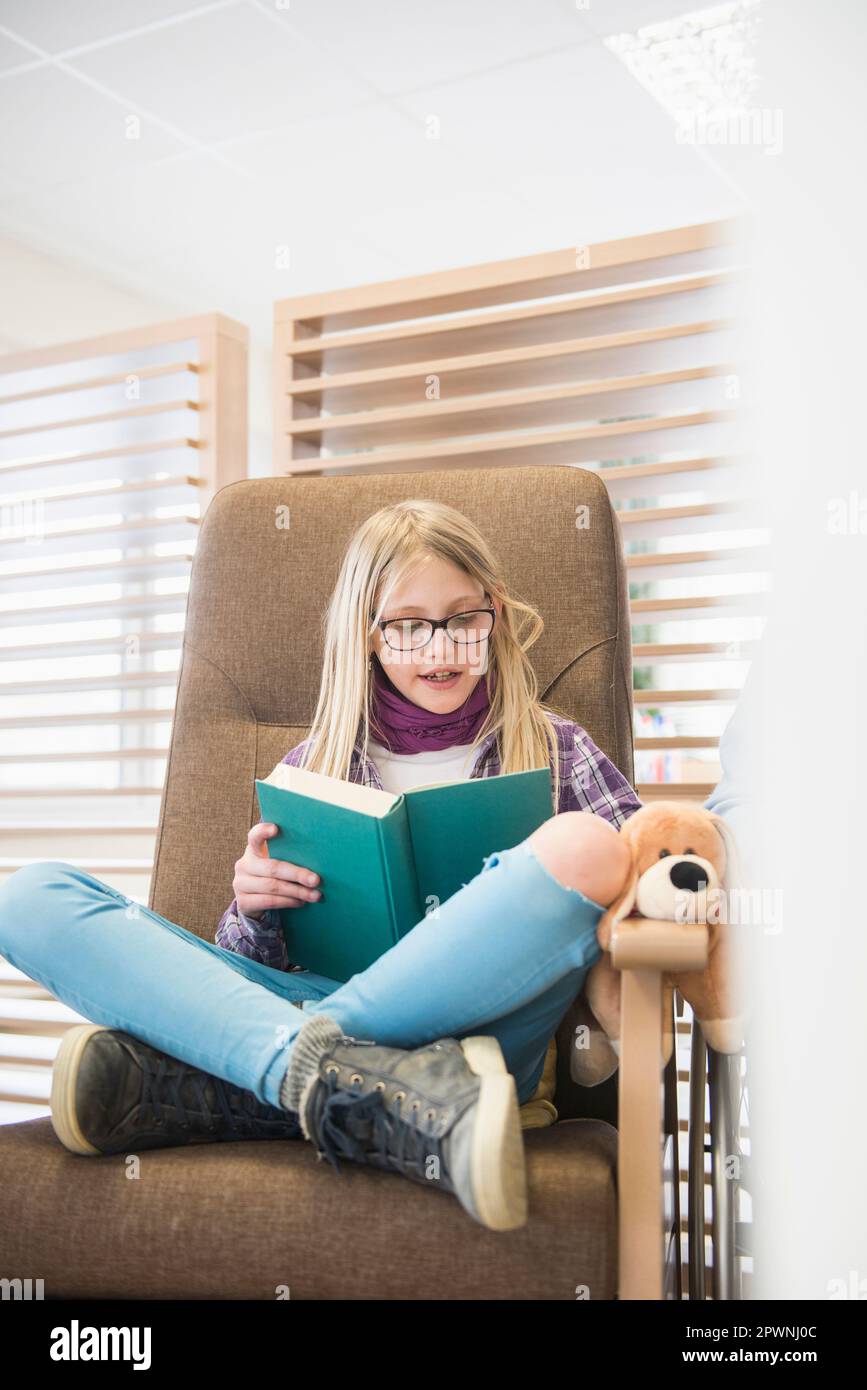 Girl reading a book Stock Photo - Alamy