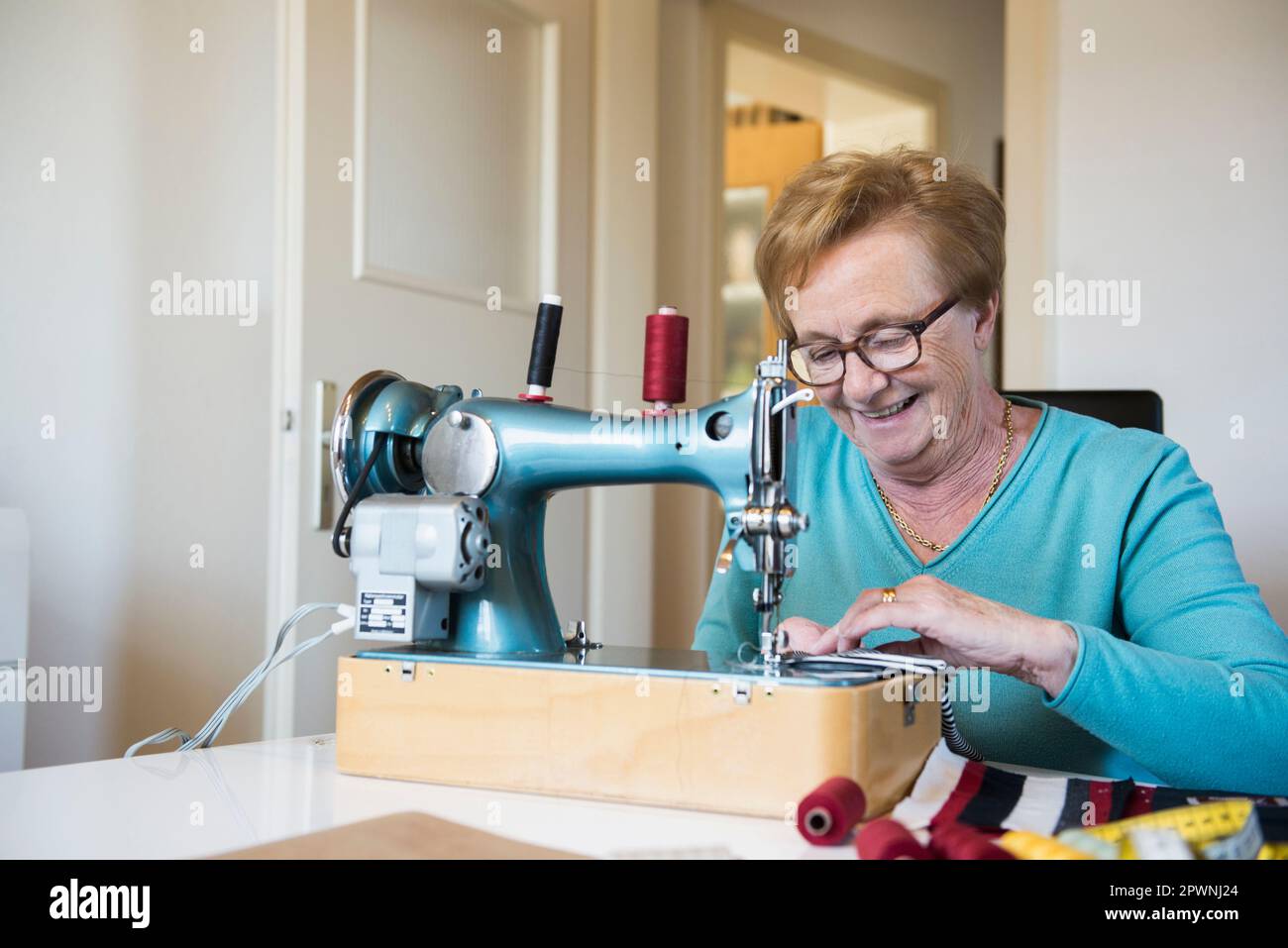 Old woman sewing on a machine Stock Photo - Alamy
