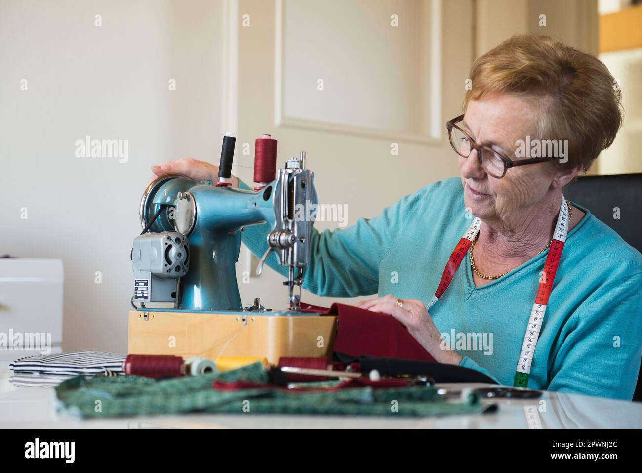 Old woman sewing on a machine Stock Photo - Alamy