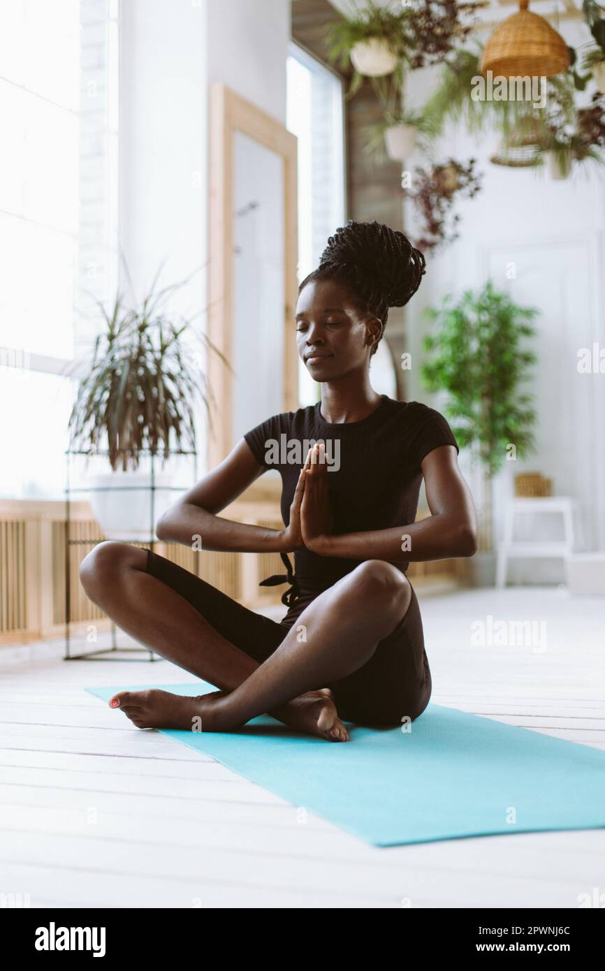 Vertical calm and spiritual young dark skin woman with close eyes, join ...