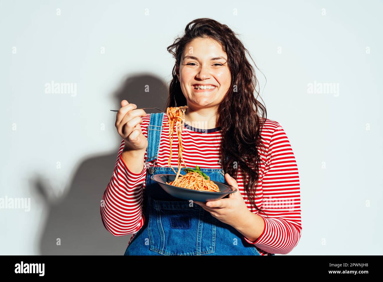 Plus size woman model posing in studio and having fun. Happy model ...