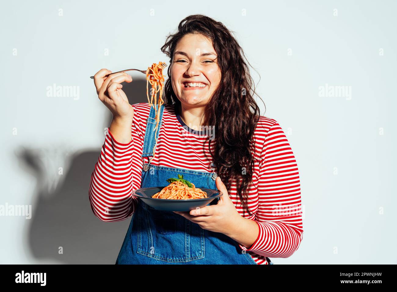 Plus size woman model posing in studio and having fun. Happy model ...
