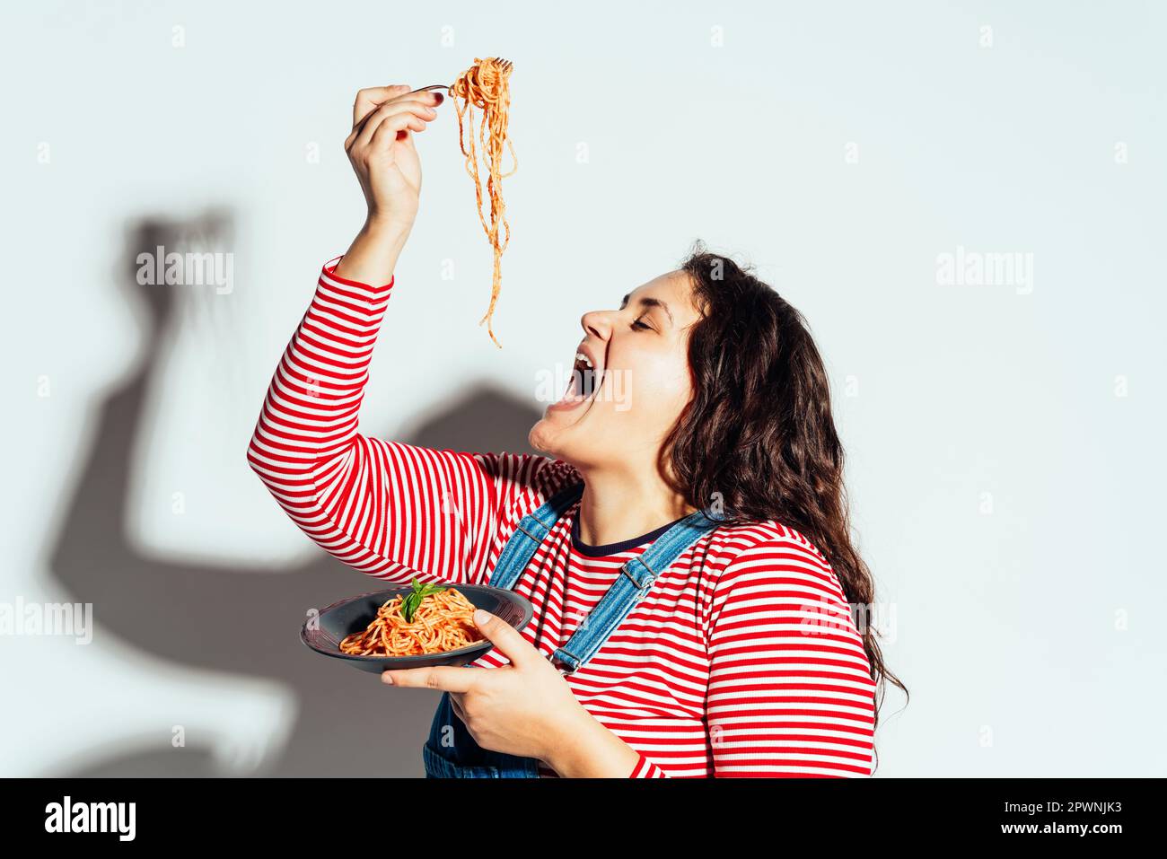 Plus size woman model posing in studio and having fun. Happy model ...