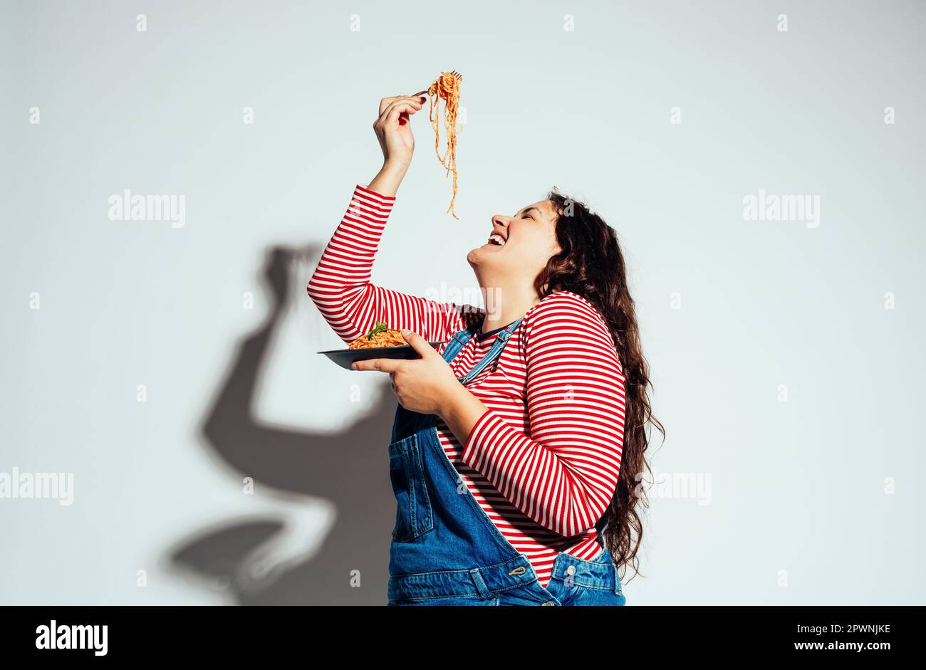 Plus size woman model posing in studio and having fun. Happy model ...