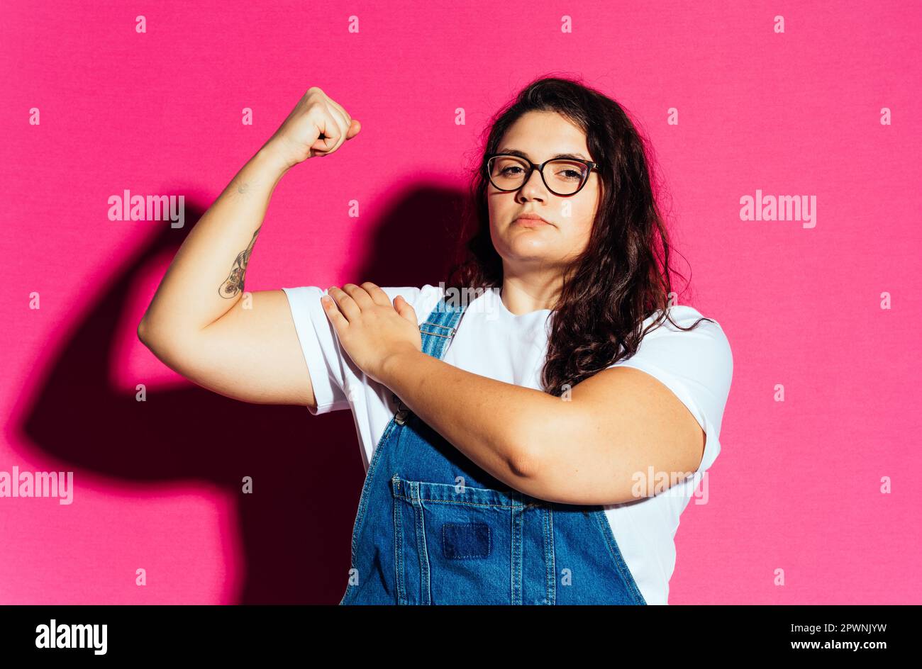 Plus size woman model posing in studio and having fun on colored ...
