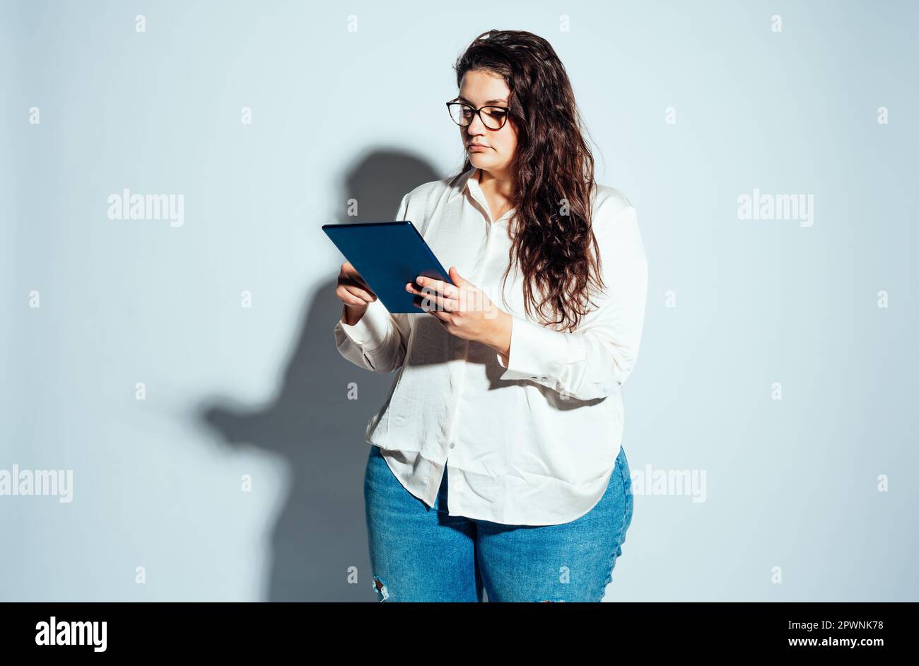 Plus size woman model posing in studio and having fun on white ...