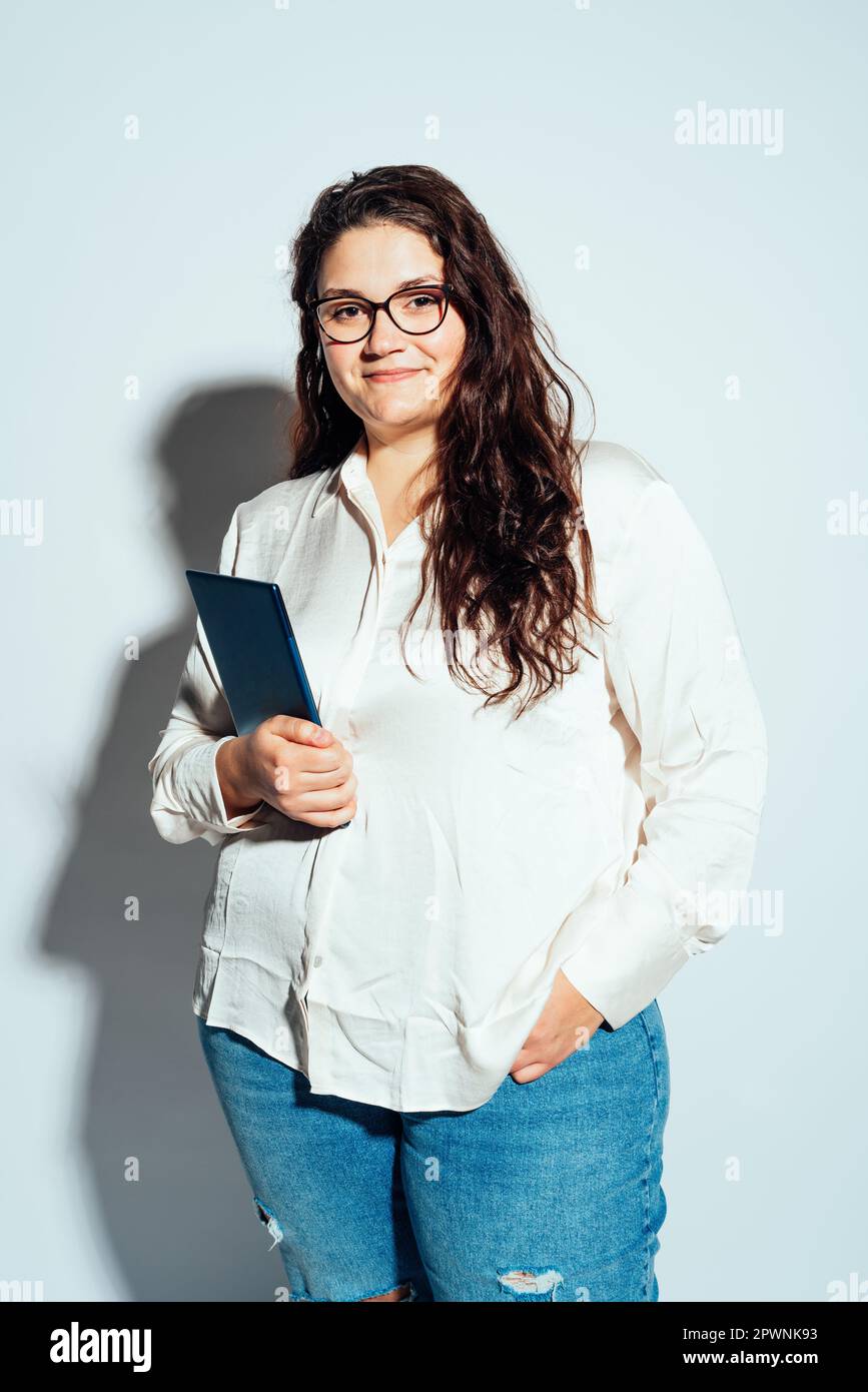 Plus size woman model posing in studio and having fun on white ...