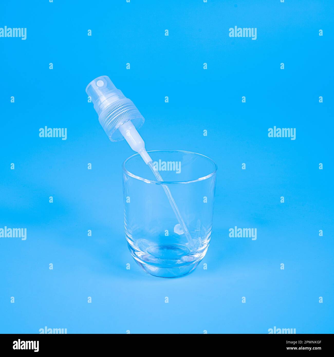 the spray pump tube into a glass Stock Photo - Alamy