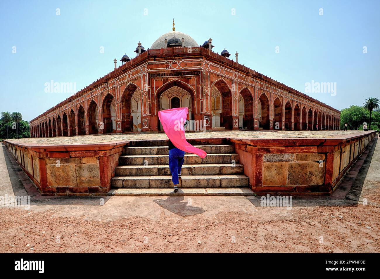 Delhi, India. 21st Apr, 2023. A woman with a colorful scarf walks ...