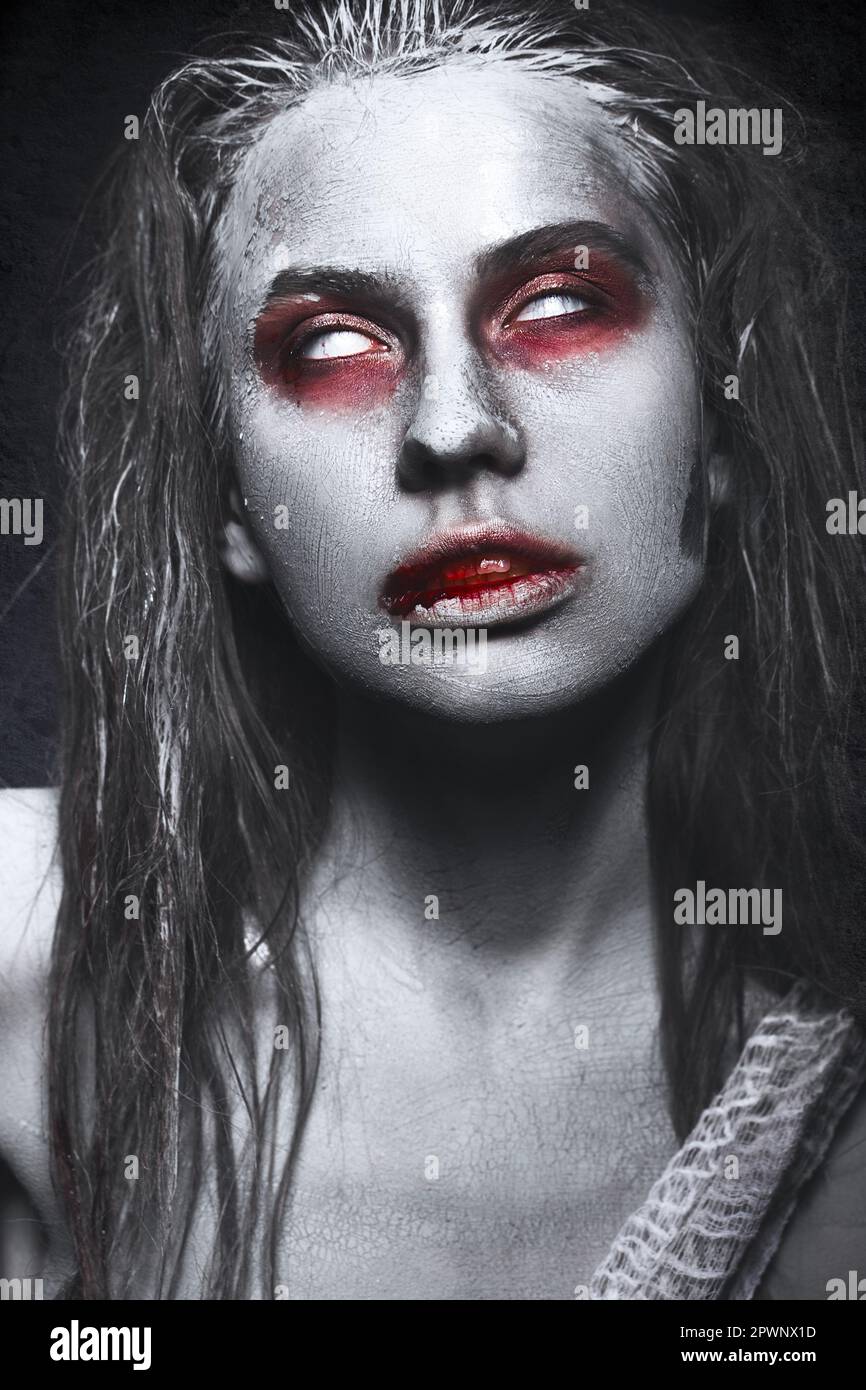 Girl in the form of zombies, Halloween corpse with blood on his lips ...