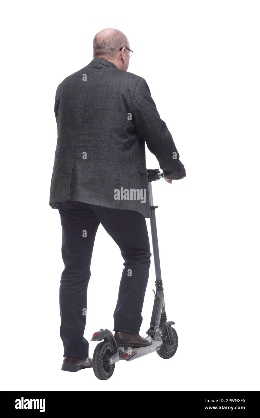 rear view . Mature man leaving on an electric scooter Stock Photo - Alamy