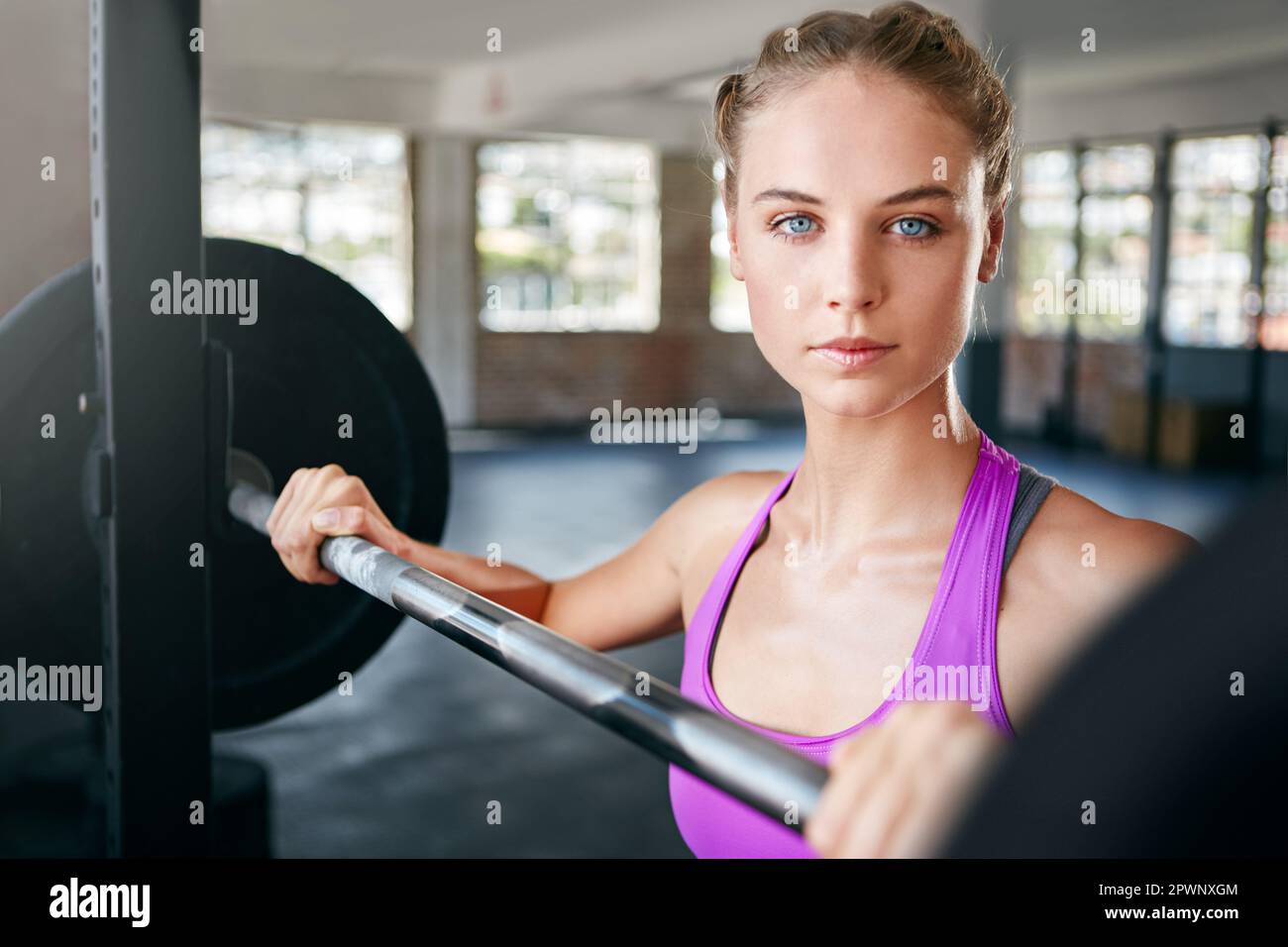 I am powerful beyond measure. a young woman working out with weights at the gym Stock Photo - Alamy
