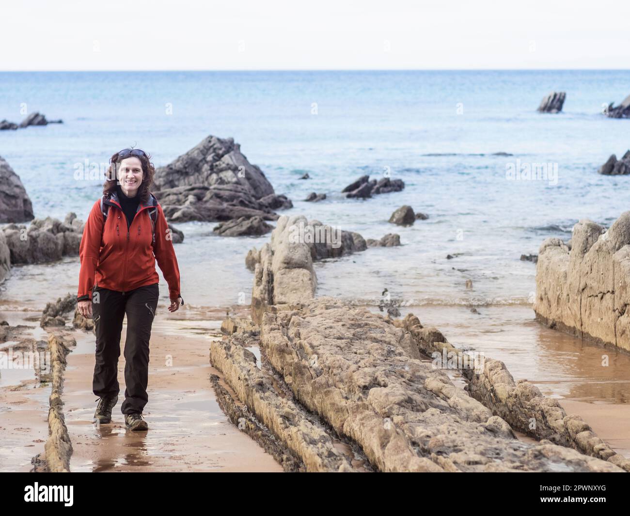 Woman hiking along at the cliffs of barrika Stock Photo - Alamy