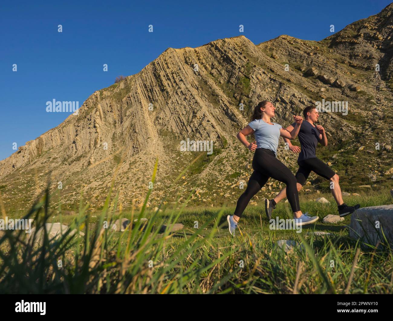 Man running cliff hi-res stock photography and images - Alamy