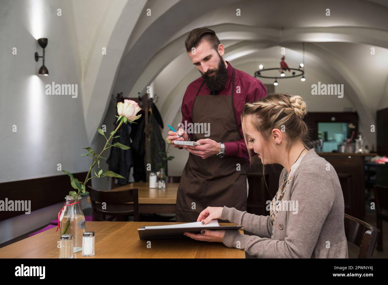 Woman in restaurant placing order Stock Photo - Alamy