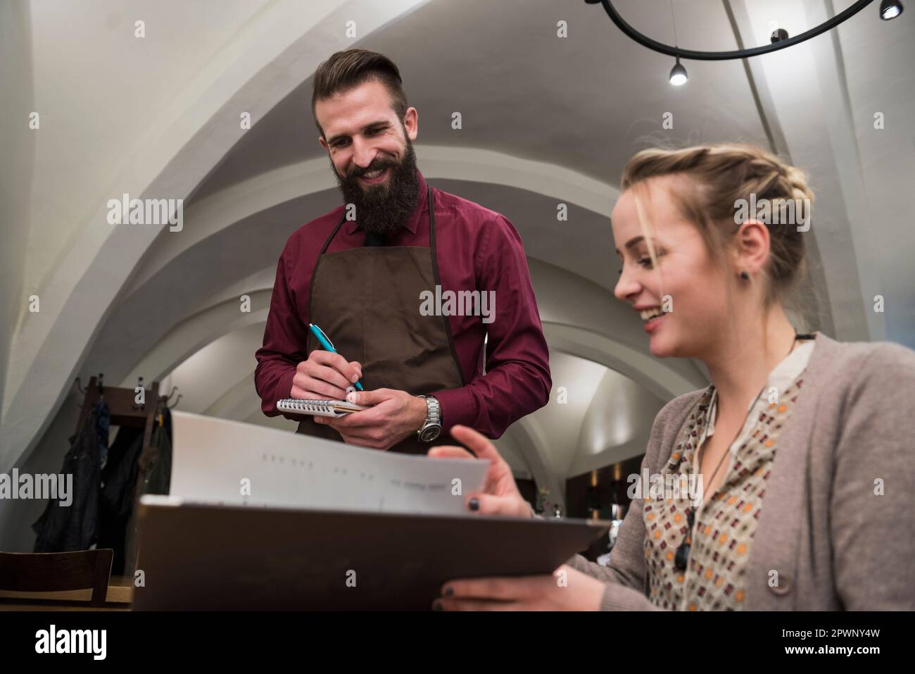 Woman in restaurant placing order Stock Photo - Alamy