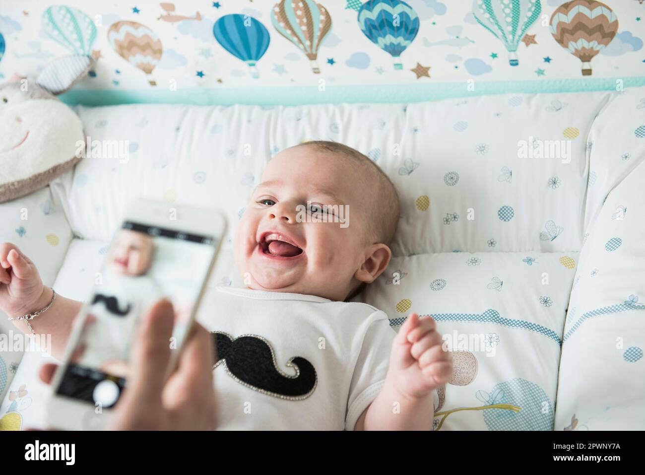 Mother photographing her baby using mobile phone Stock Photo - Alamy