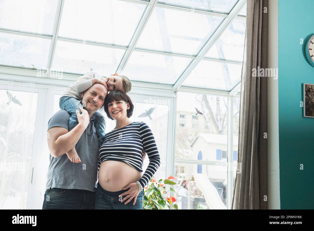 Portrait of parents carrying baby on shoulders Stock Photo - Alamy