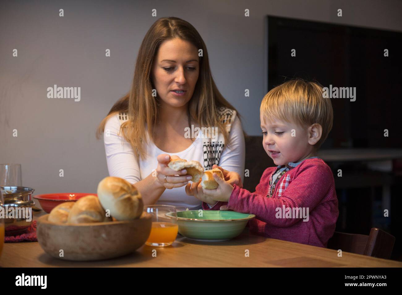 Mother is sharing bread with her son, Munich, Germany Stock Photo - Alamy