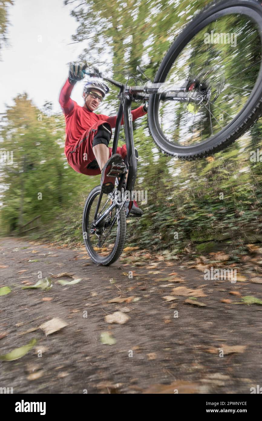 Mountain biker wheelie on bike hi-res stock photography and images - Alamy