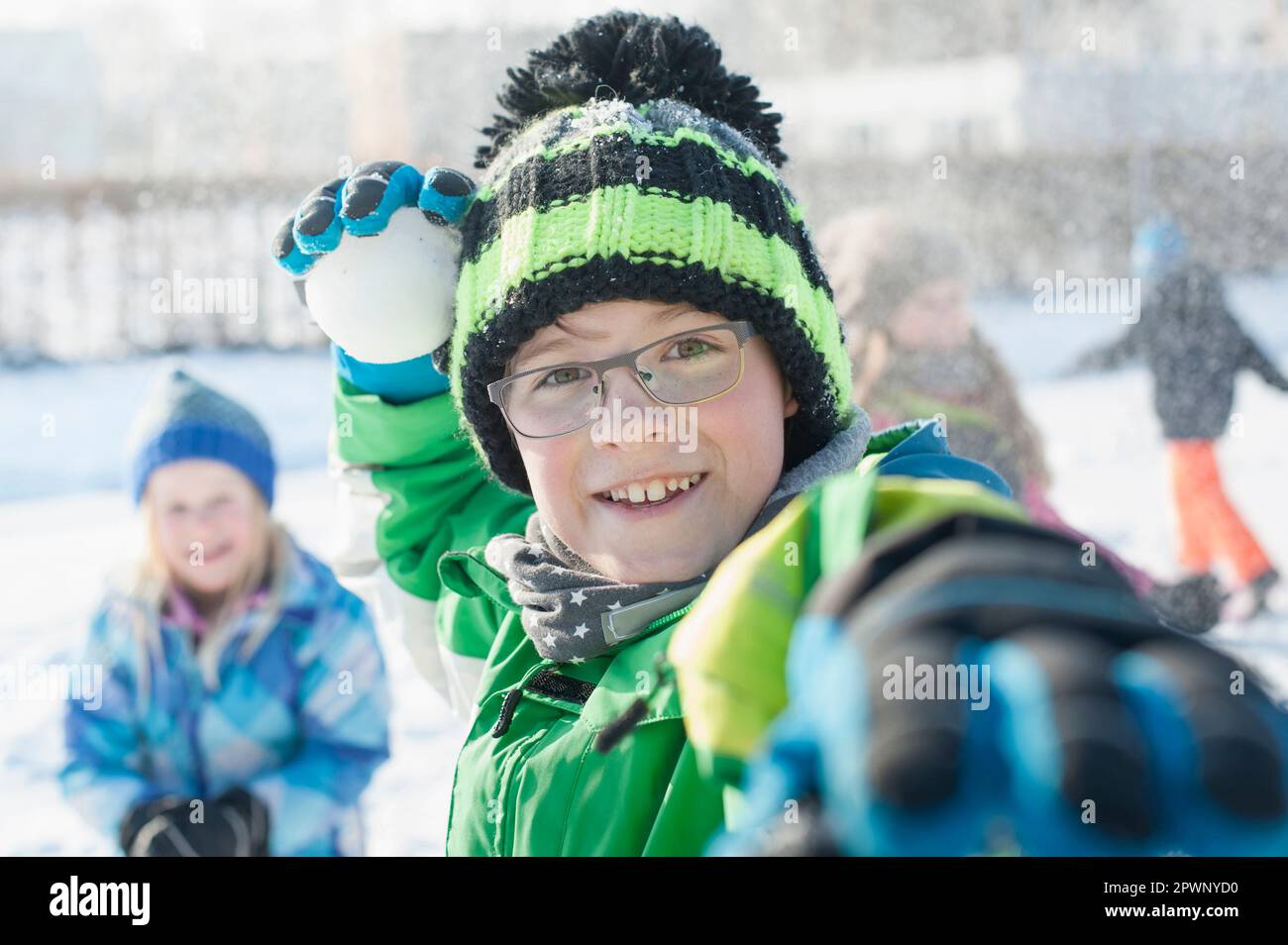 Portrait of boy throwing snowball Stock Photo - Alamy