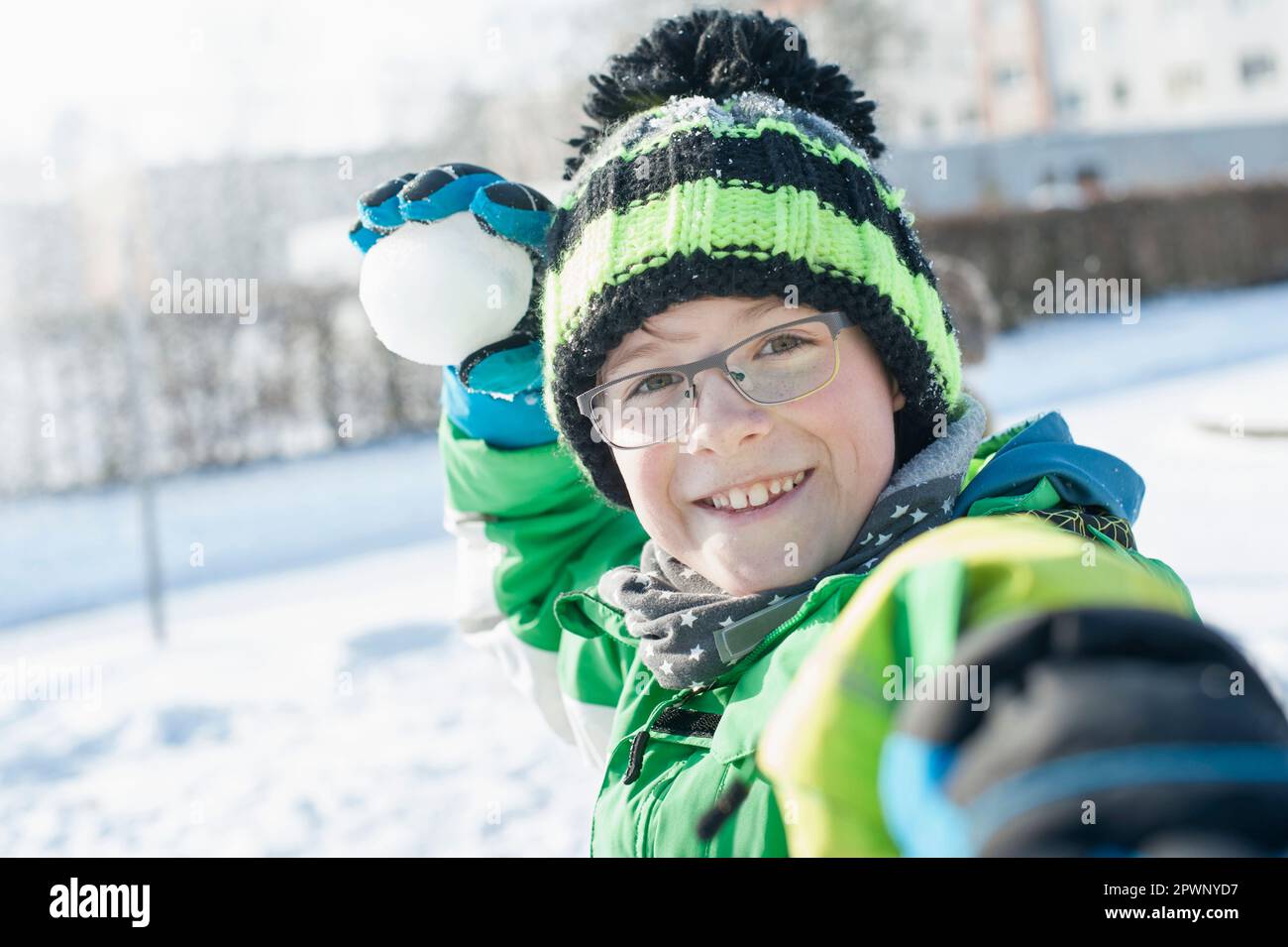 Boy is throwing snowball hi-res stock photography and images - Alamy