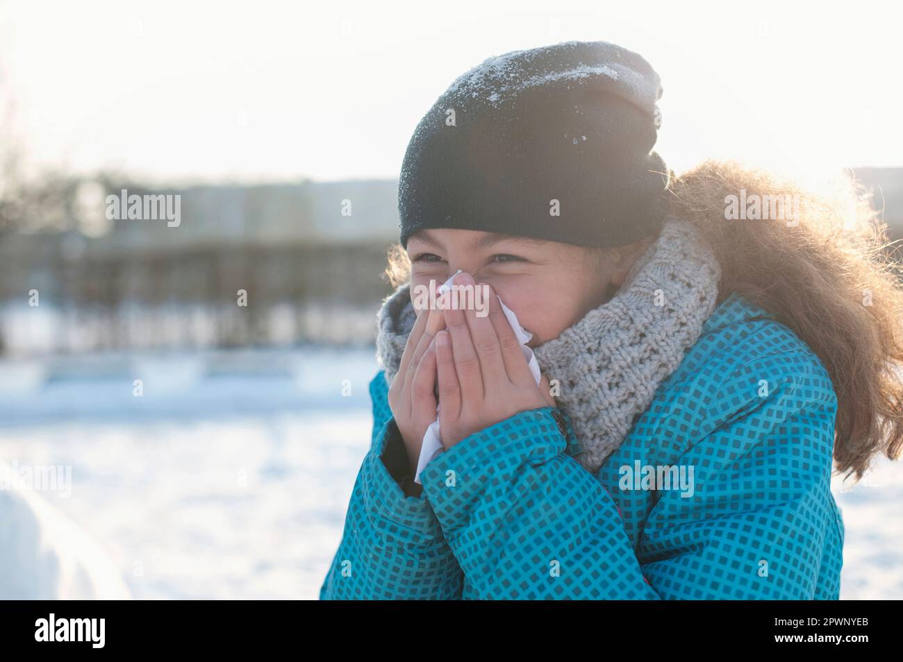 Girl sneezing in winter Stock Photo - Alamy