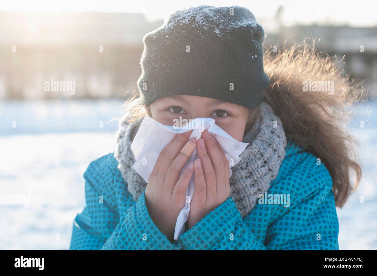 Portrait of girl blowing nose in winter Stock Photo - Alamy