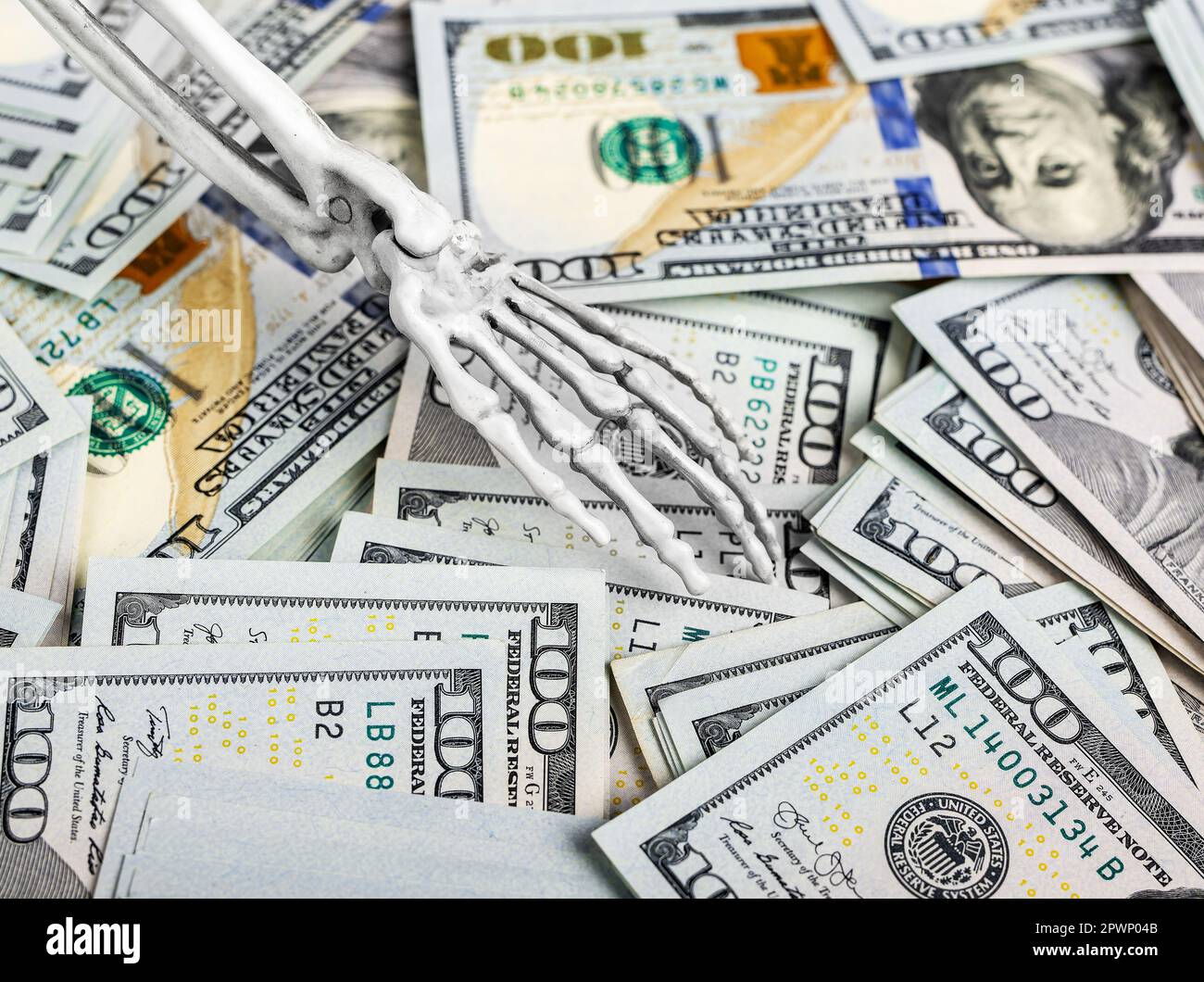 Life and death insurance concept. Skeleton arm hand on money pile heap ...