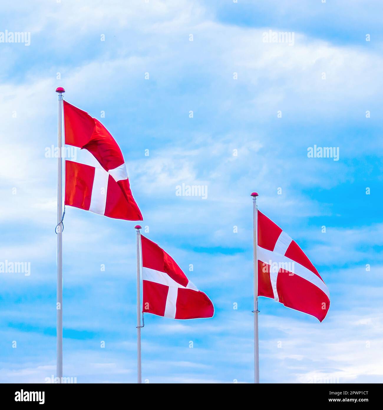 Three flags of the Kingdom of Denmark waving in the wind Stock Photo ...