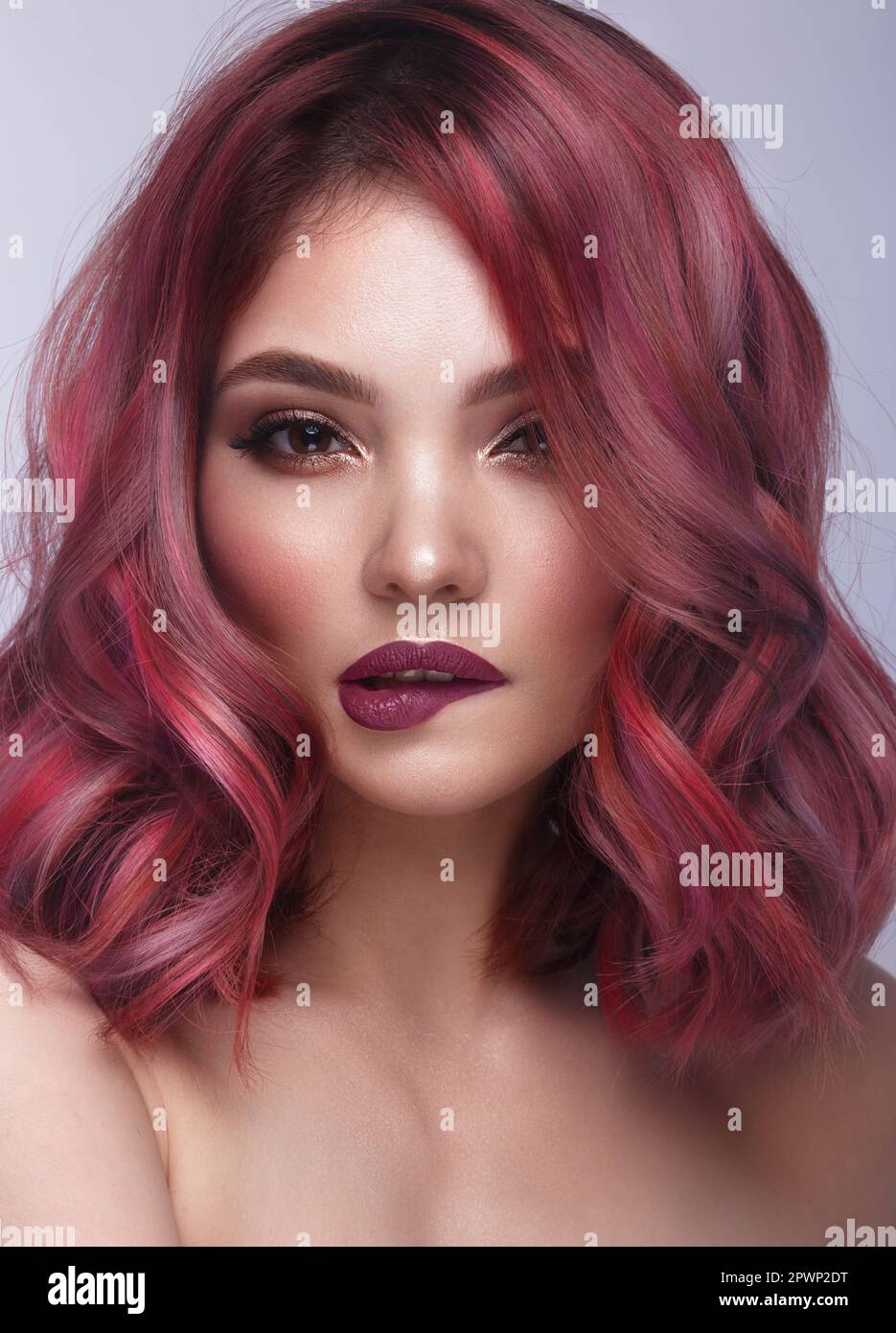 Beautiful girl with multi-colored hair and classic make-up and ...