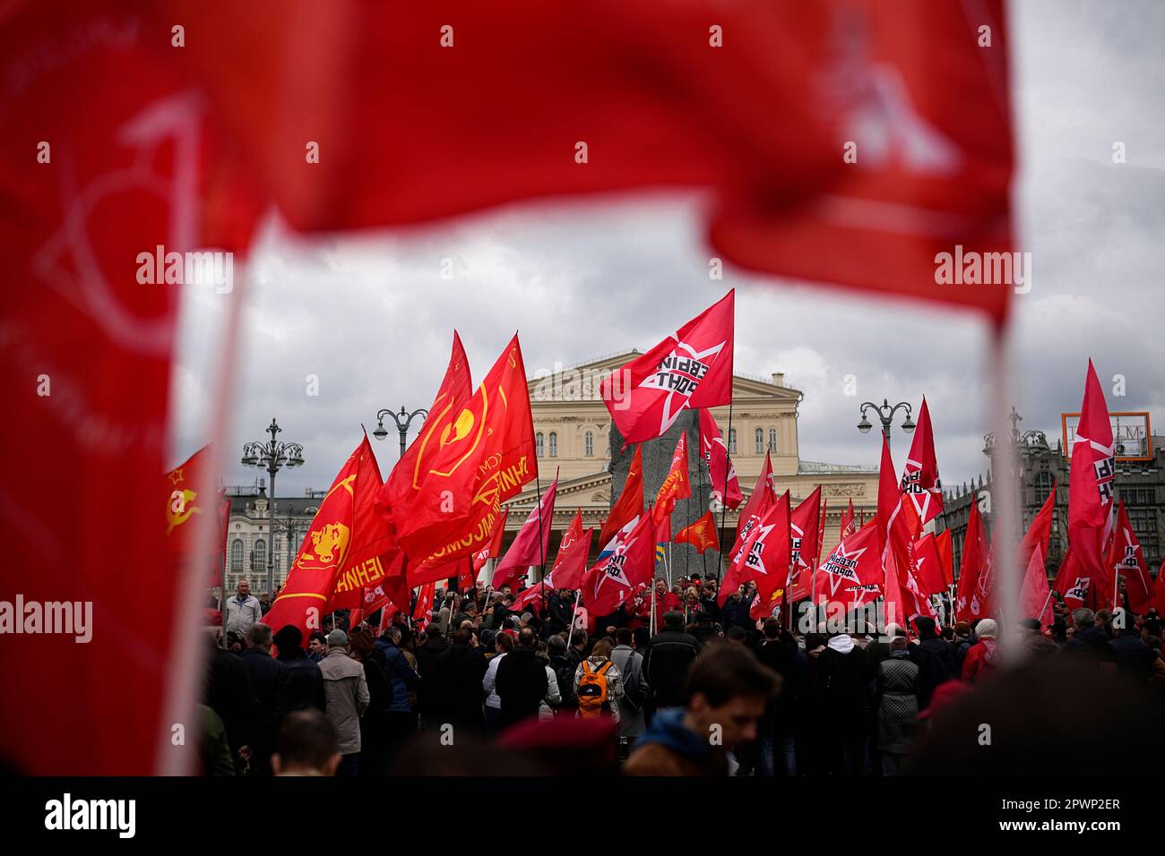 Communists party supporters wave red flags as they gather to mark Labor ...