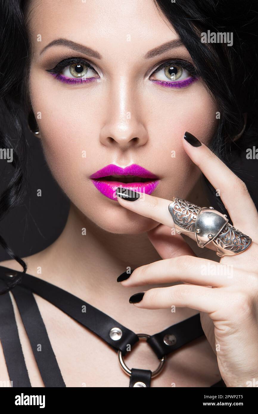 Beautiful Girl in the Gothic style with leather accessories and bright ...