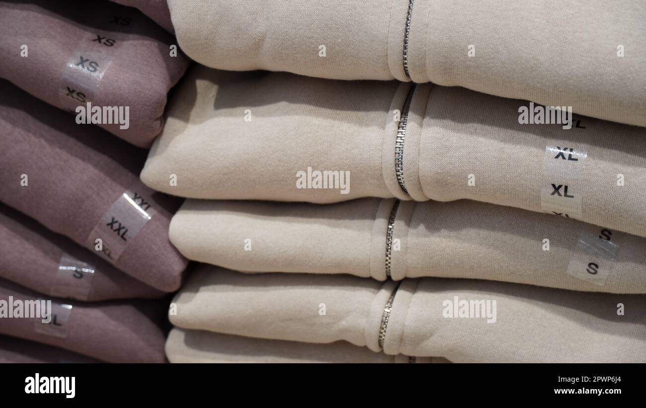 Stack of cloth different colors and sizes on the shelves in a clothes ...