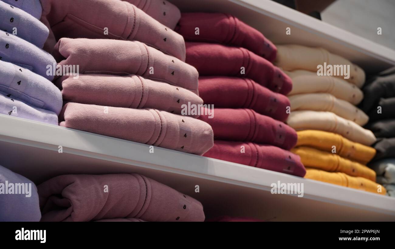 Stack of cloth different colors and sizes on the shelves in a clothes ...